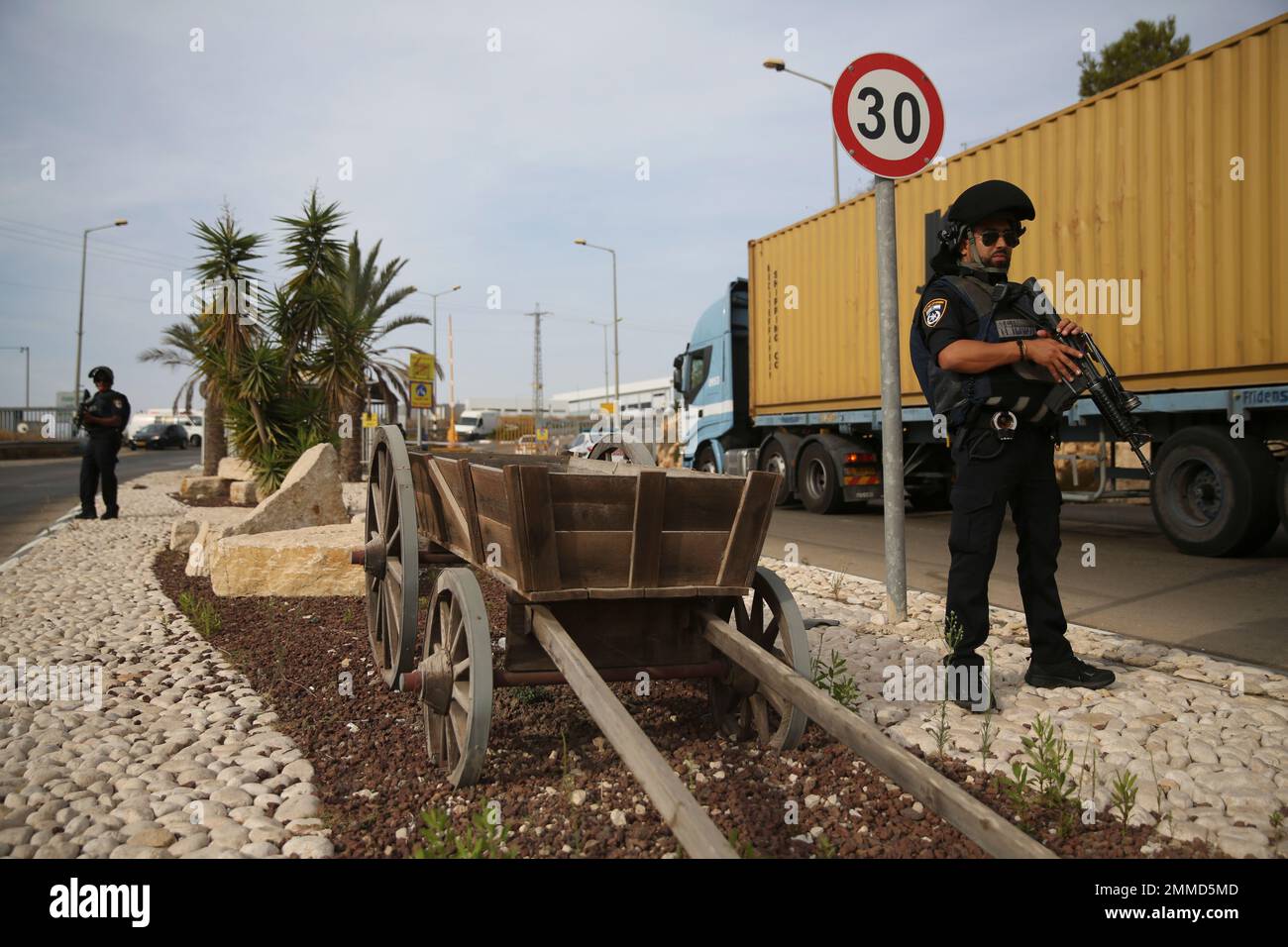 Israeli policemen stand at then entrance of Barkan industrial zone in ...