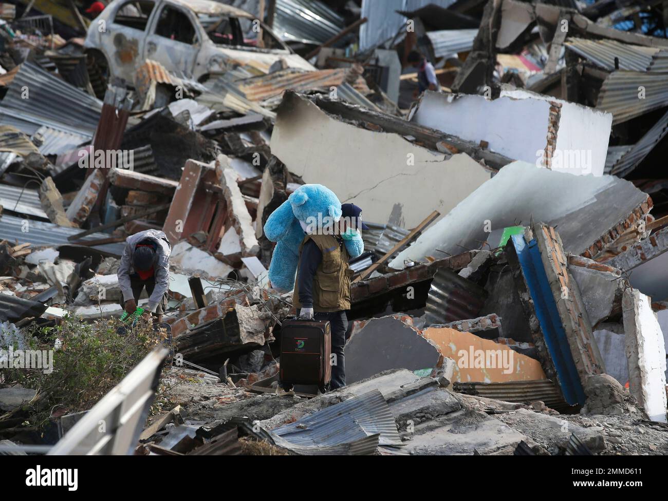In this Saturday, Oct. 6, 2018, file photo, a man carries a teddy bear ...
