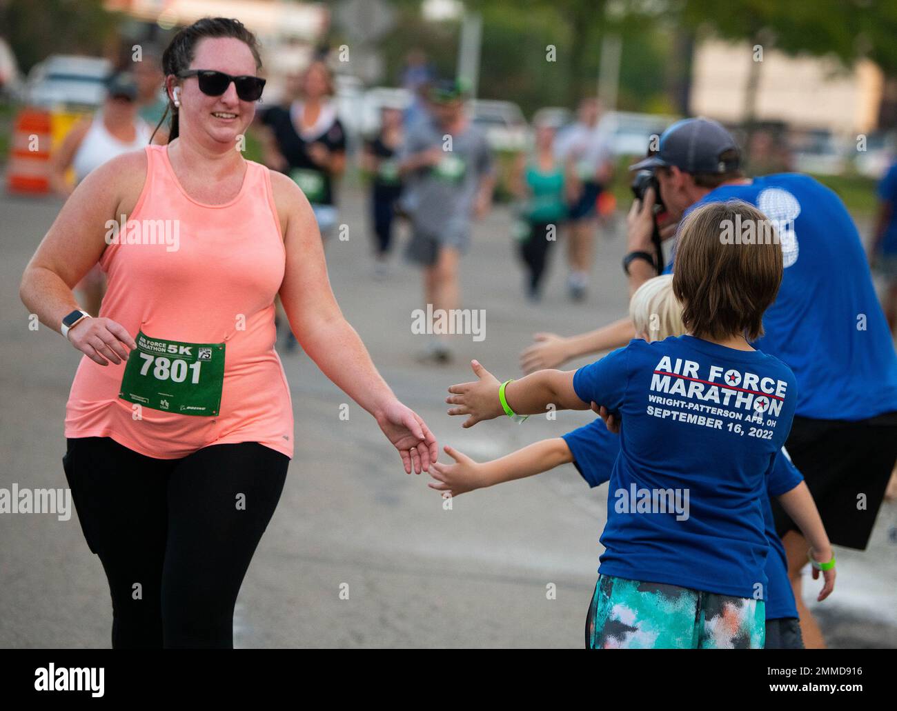 Spectators congratulate Meghan Neal as she nears the finishing line of ...
