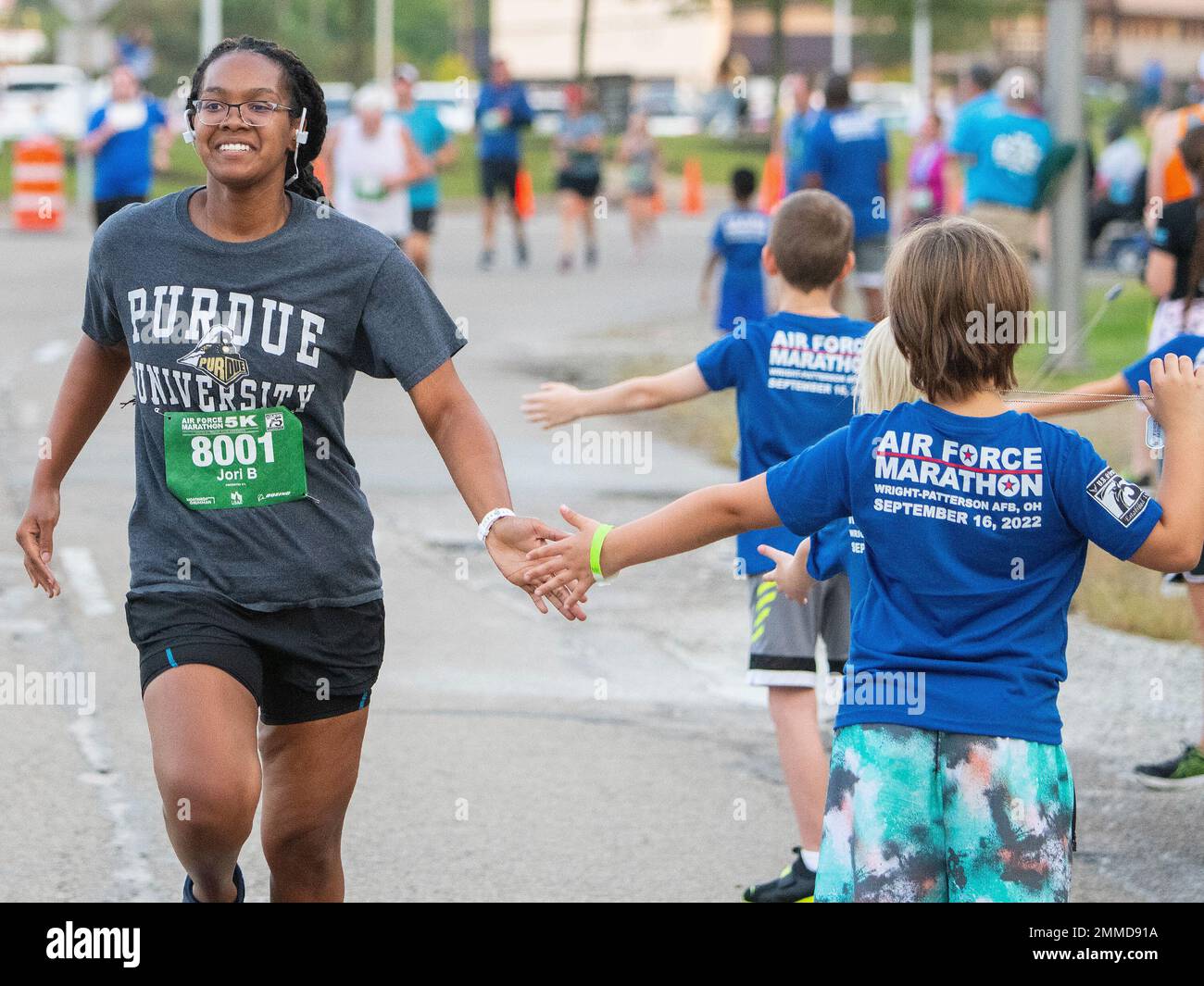 Spectators congratulate Jorian Brown as she nears the finishing line of ...