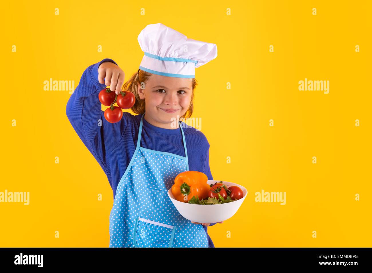 Kid cook hold tomato. Cooking, culinary and kids. Little boy in chefs ...