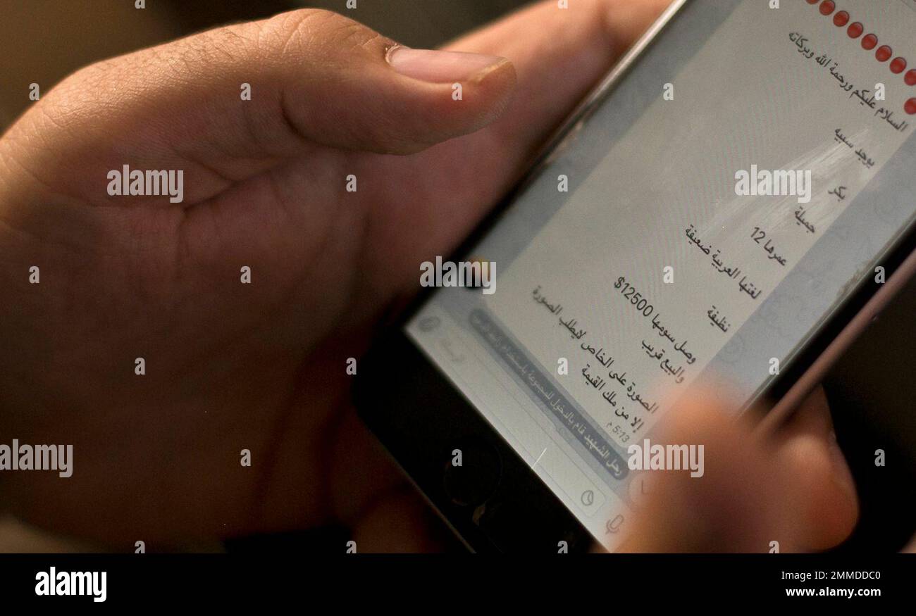 FILE - In this May 22, 2016 file photo, An activist looks at an Islamic State group marketplace ...