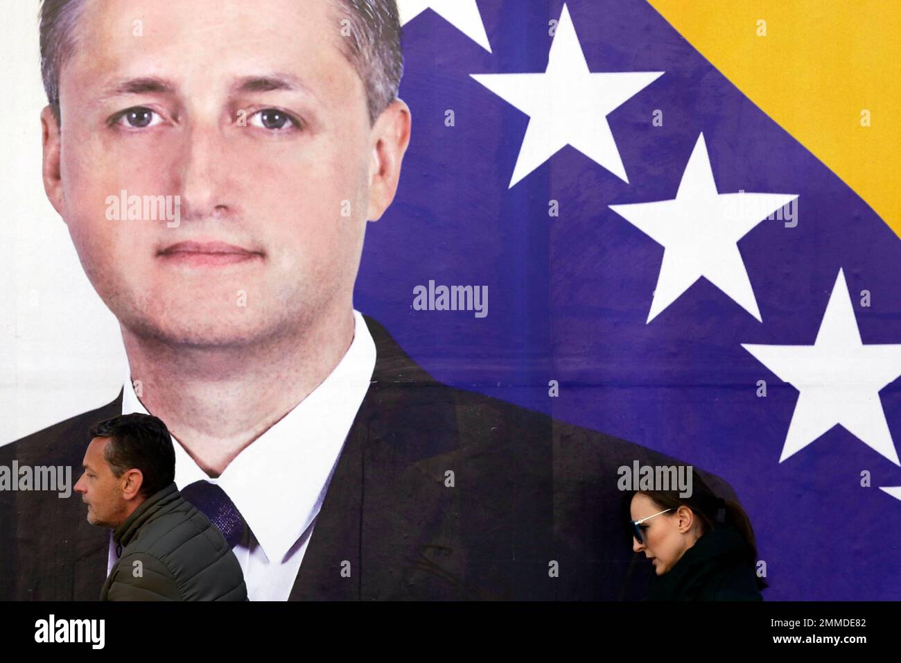 In this photo taken on Monday, Oct. 1, 2018, people pass by an election ...