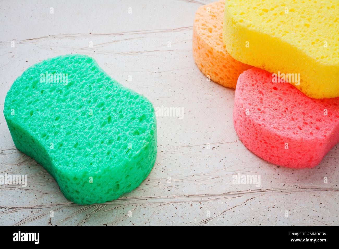 colorful sponges with soap bubbles for washing Stock Photo - Alamy