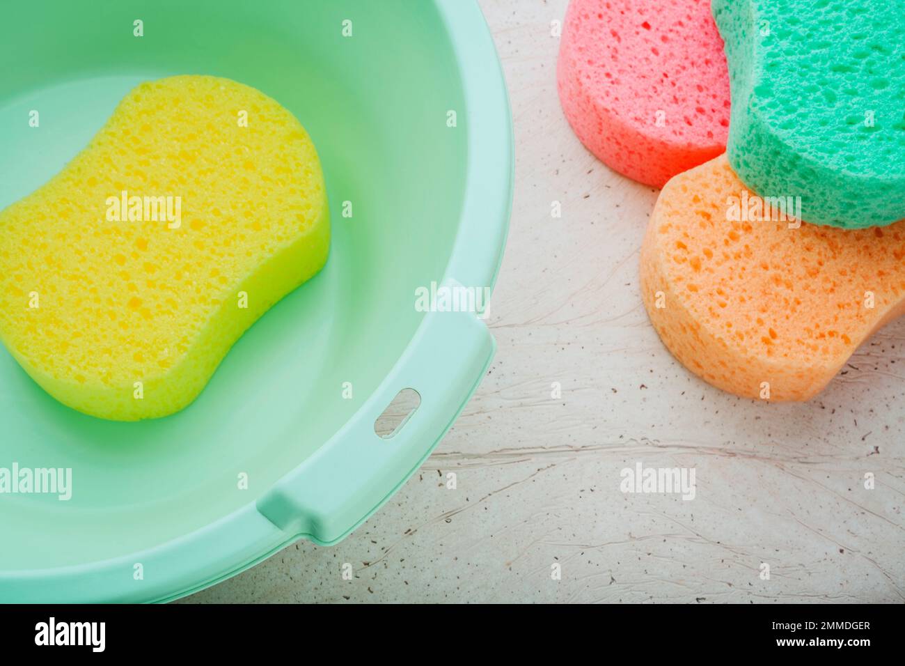 colorful sponges with soap bubbles for washing Stock Photo - Alamy