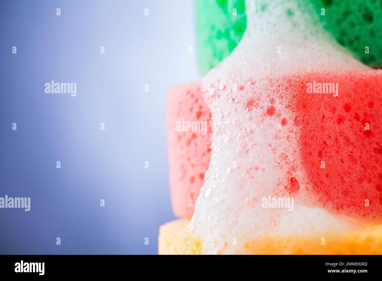 colorful sponges with soap bubbles for washing Stock Photo - Alamy