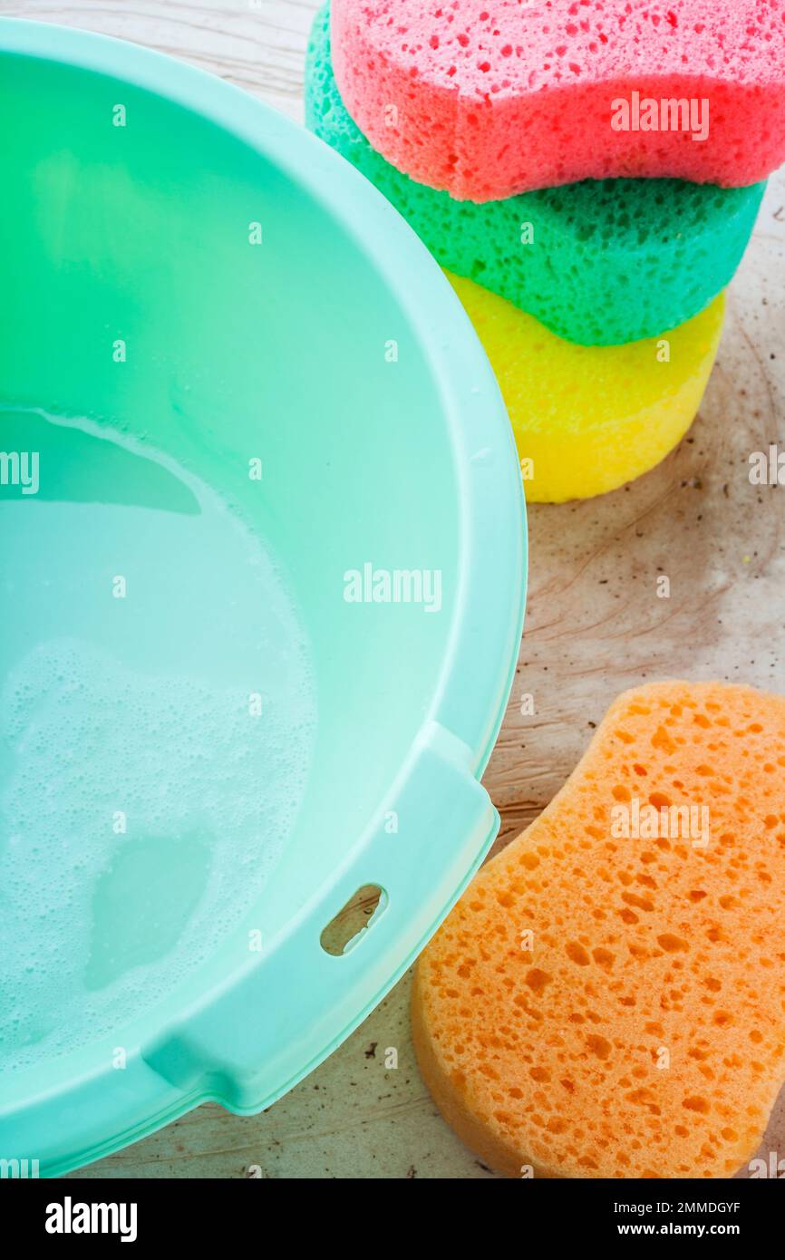 colorful sponges with soap bubbles for washing Stock Photo - Alamy