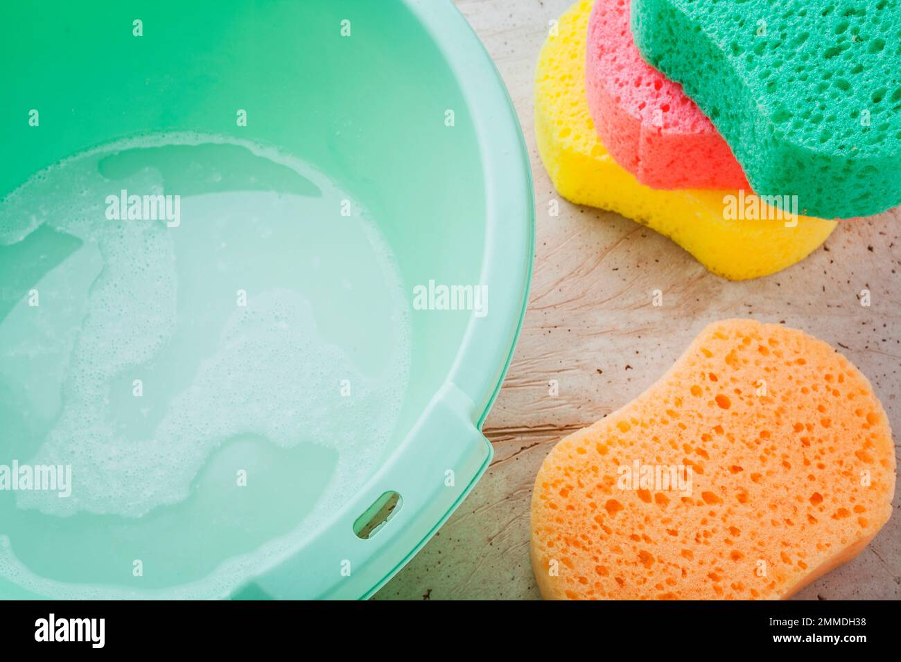 colorful sponges with soap bubbles for washing Stock Photo - Alamy
