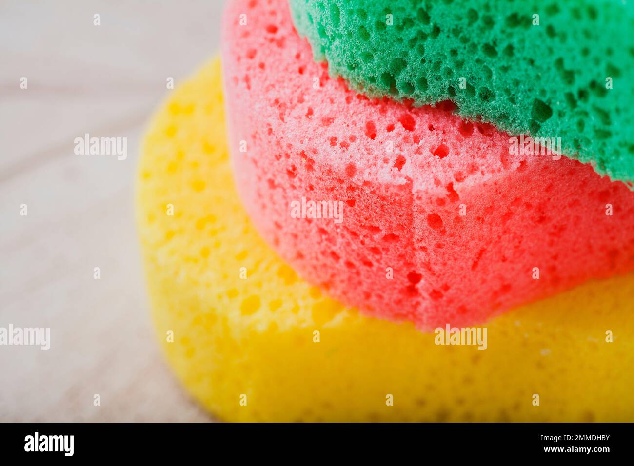 colorful sponges with soap bubbles for washing Stock Photo - Alamy
