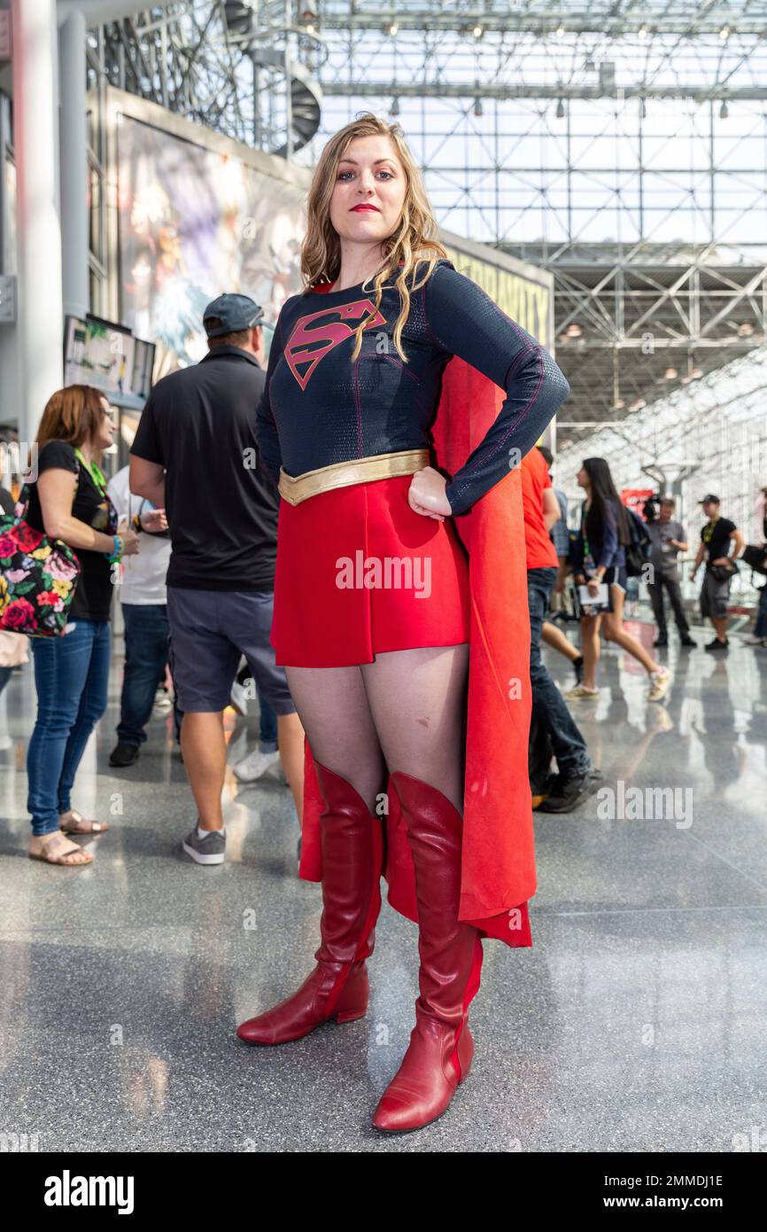 A fan dressed up as Supergirl poses for a photo during the first day of ...
