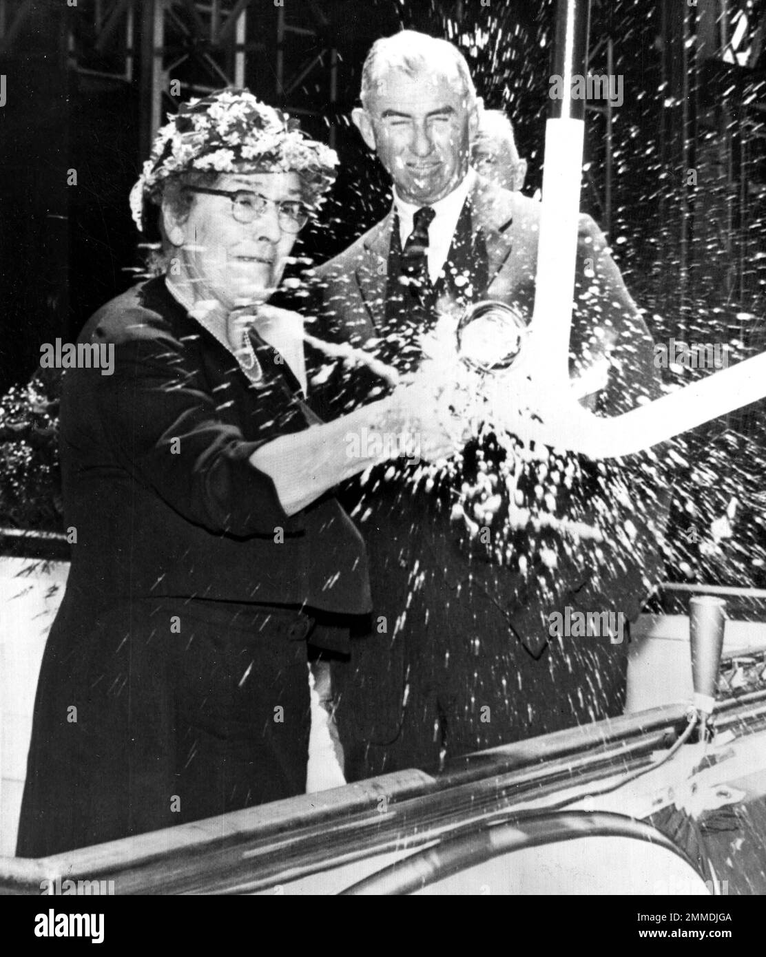 Madeleine Edison Sloane of West Orange, N.J., breaks a champagne bottle ...