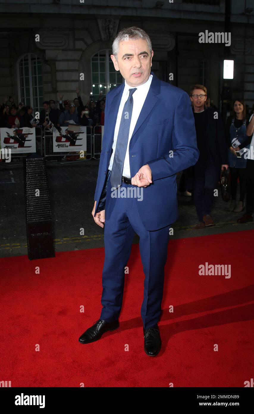 Actors Rowan Atkinson poses for photographers upon arrival for the ...