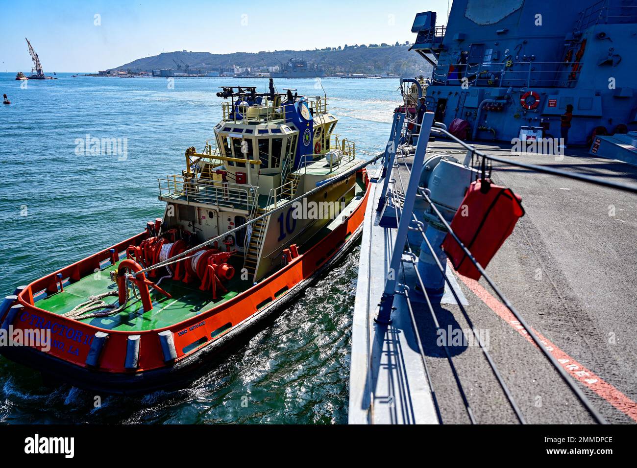The tug boat C TRACTOR 10 (IMO 8875463) helps to tow the Arleigh Burke ...
