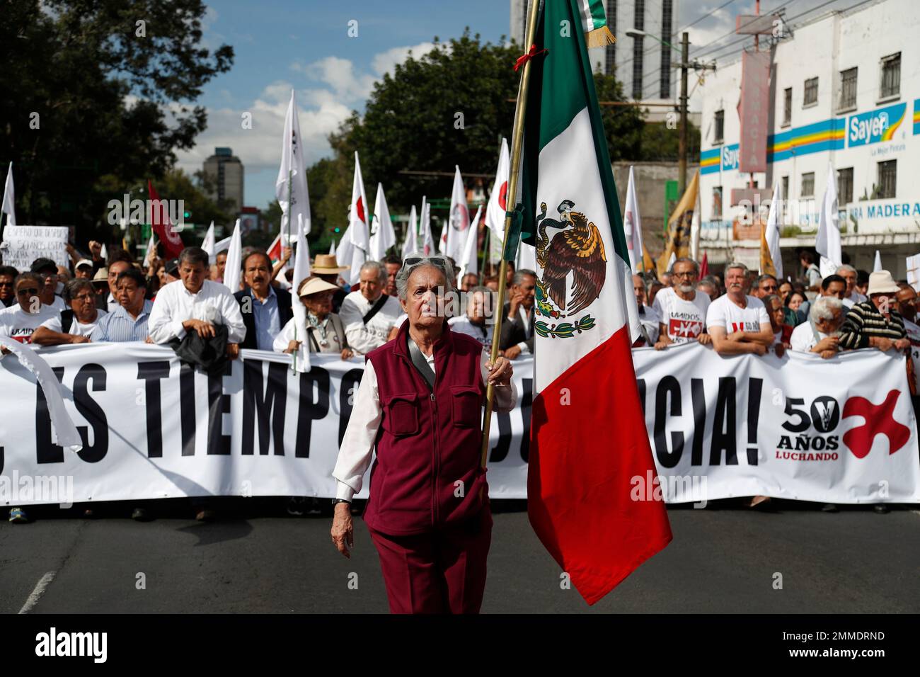 CORRECTS BYLINE - A demonstrator holds a Mexican flag leading a march ...