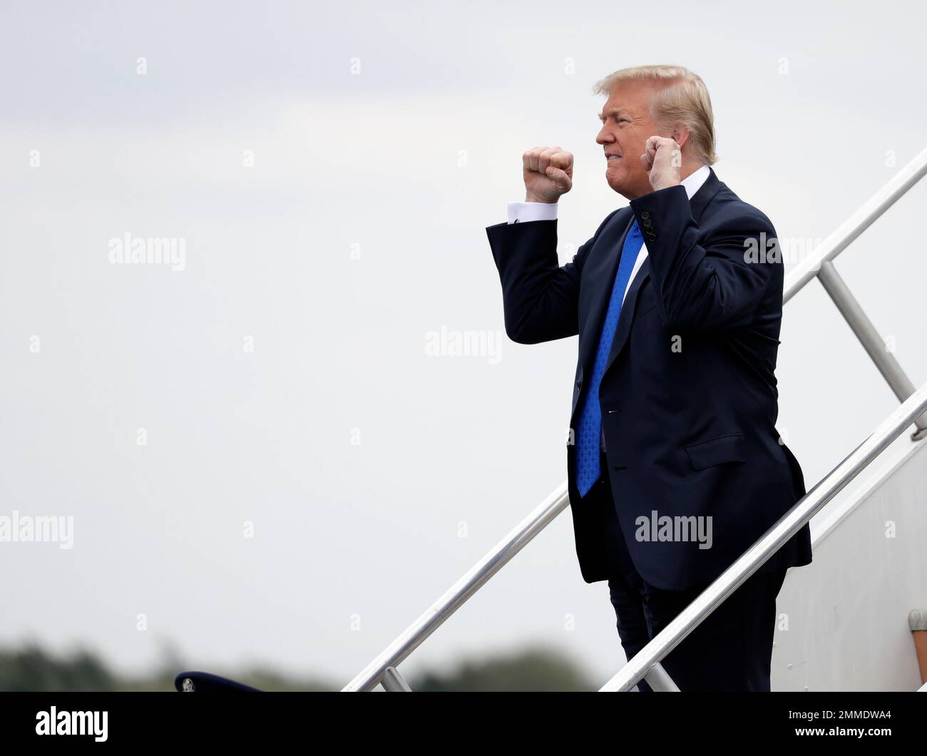 President Donald Trump gestures as he steps off Air Force One after ...