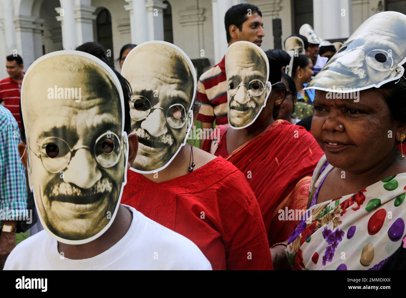 School children and teachers wearing masks of Mahatma Gandhi, the ...