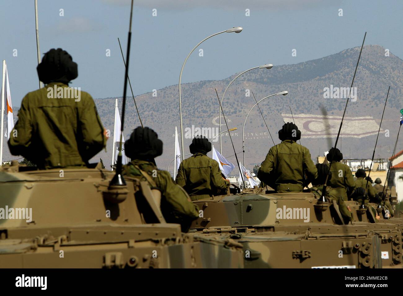 Cypriot soldiers are seen on tanks during a military parade marking the ...