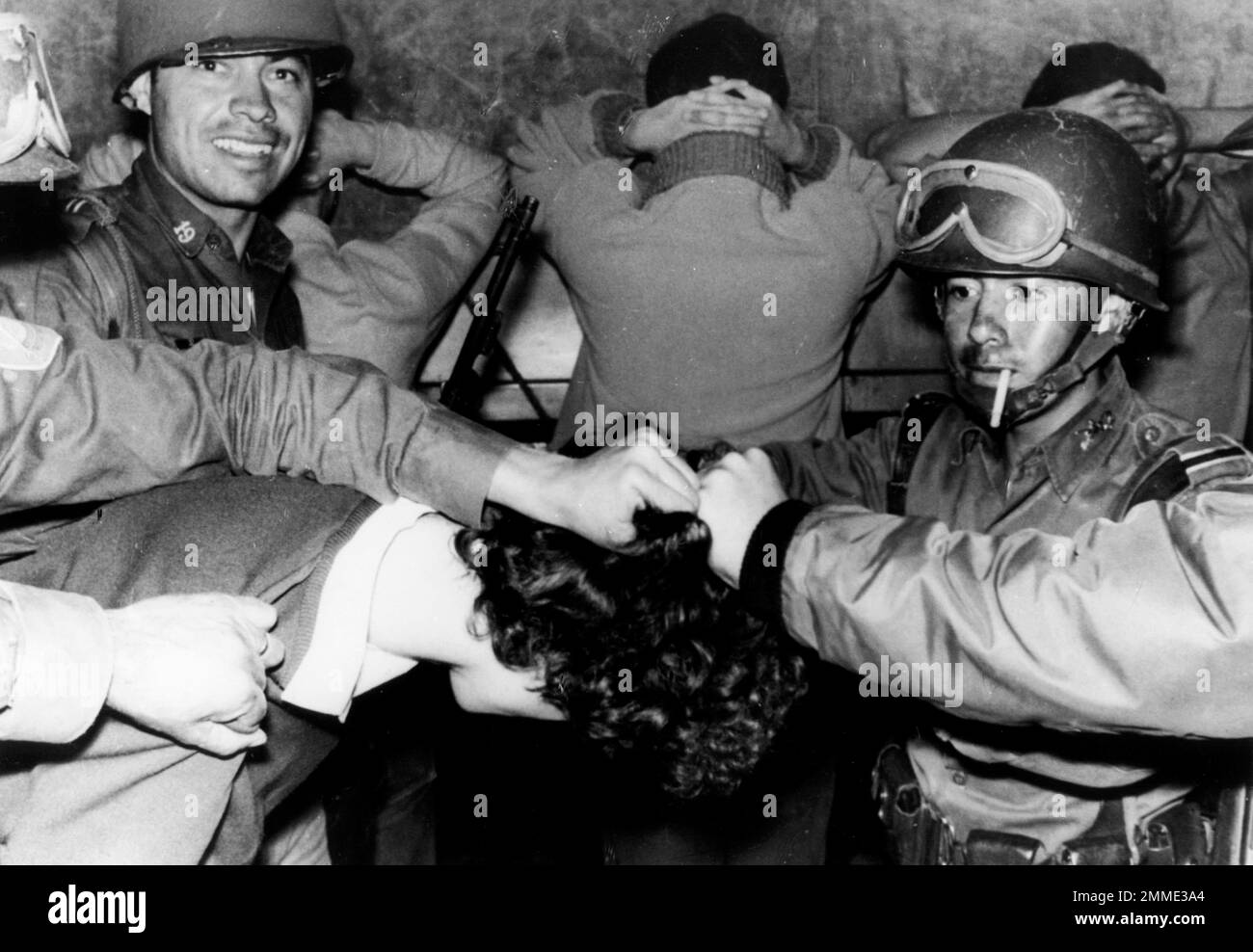 File - In this Oct. 3, 1968 file photo, soldiers cut a student's hair ...