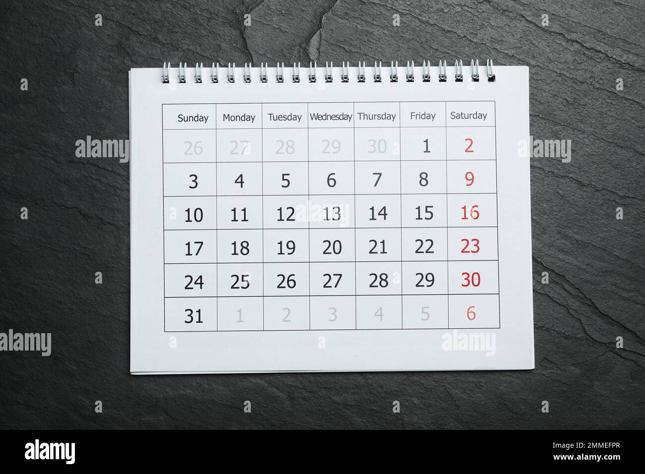 Paper calendar on black stone background, top view Stock Photo - Alamy