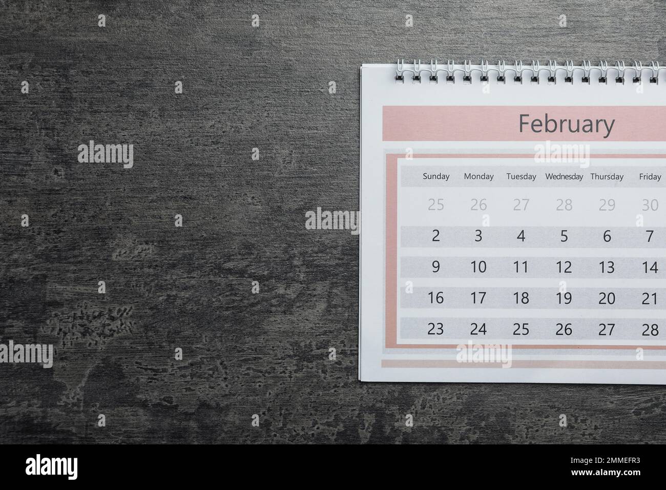 February calendar on grey stone background, top view. Space for text ...