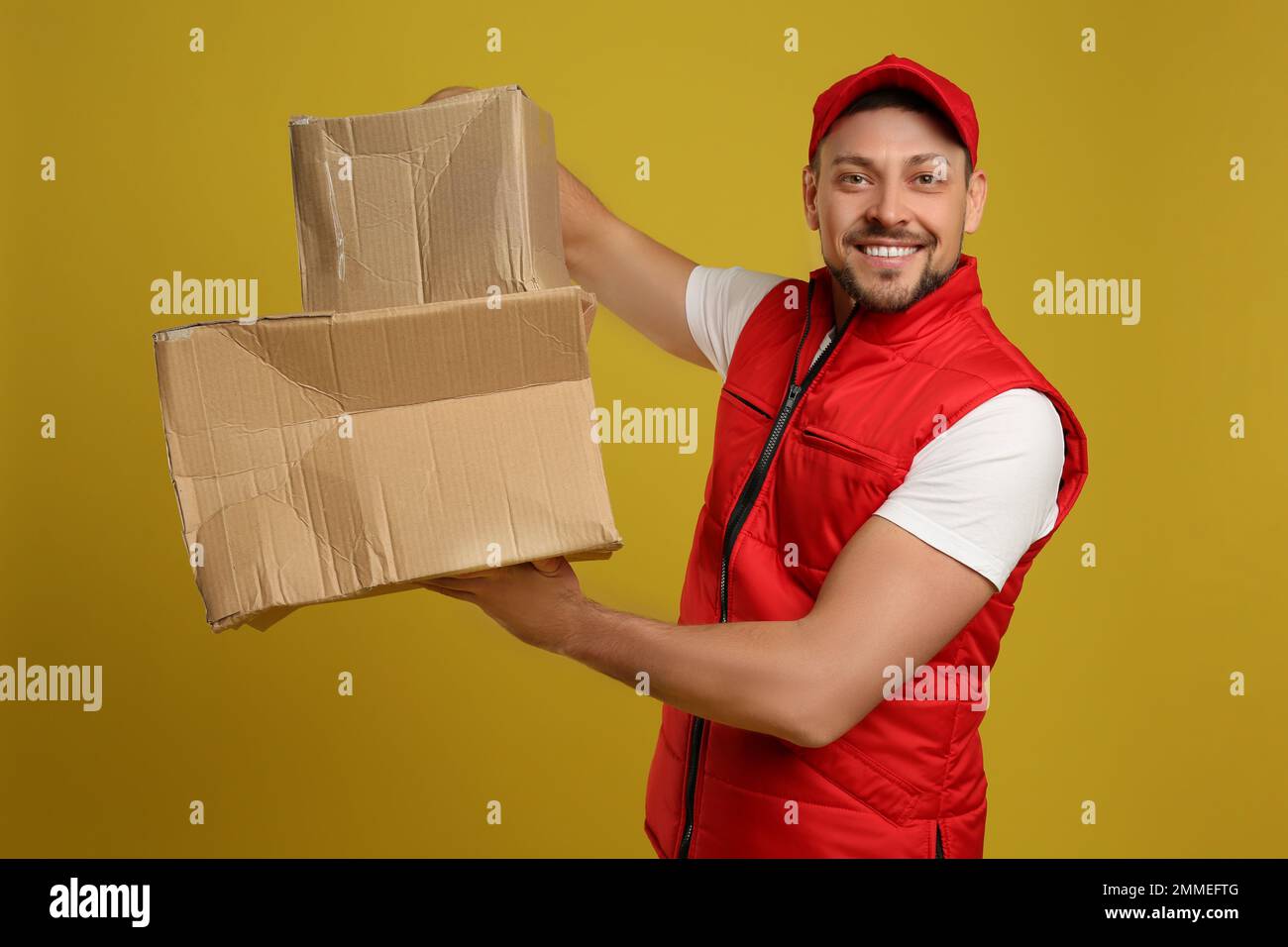 Courier with damaged cardboard boxes on yellow background. Poor quality ...
