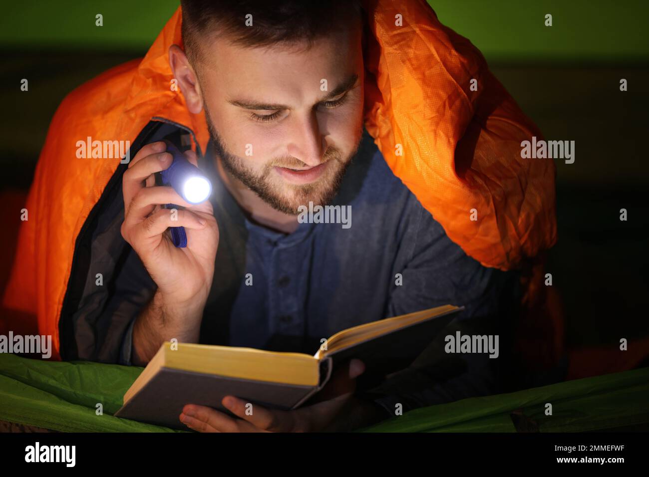 Man flashlight reading book hi-res stock photography and images - Alamy