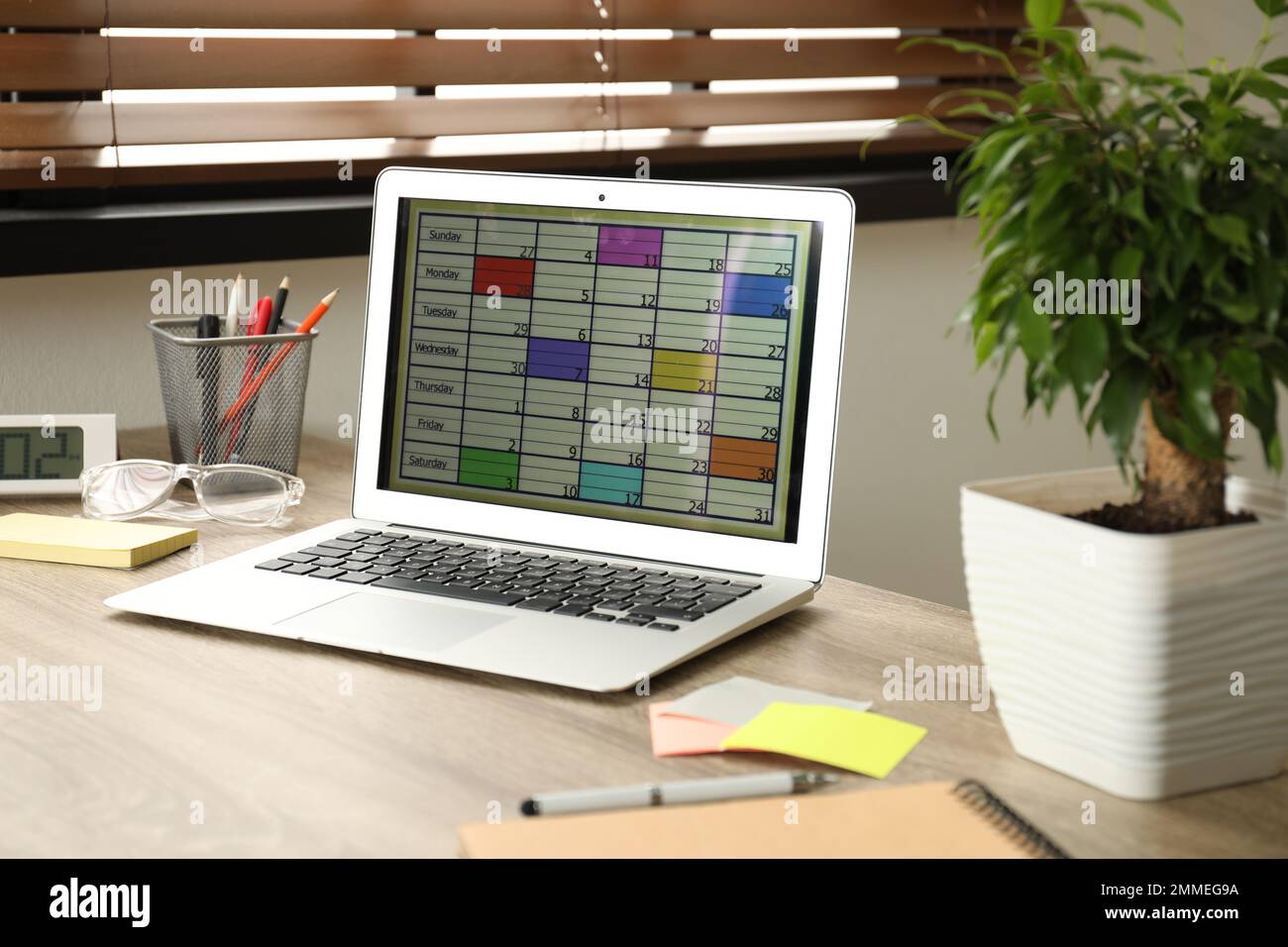 Modern laptop with calendar app at table in office Stock Photo - Alamy