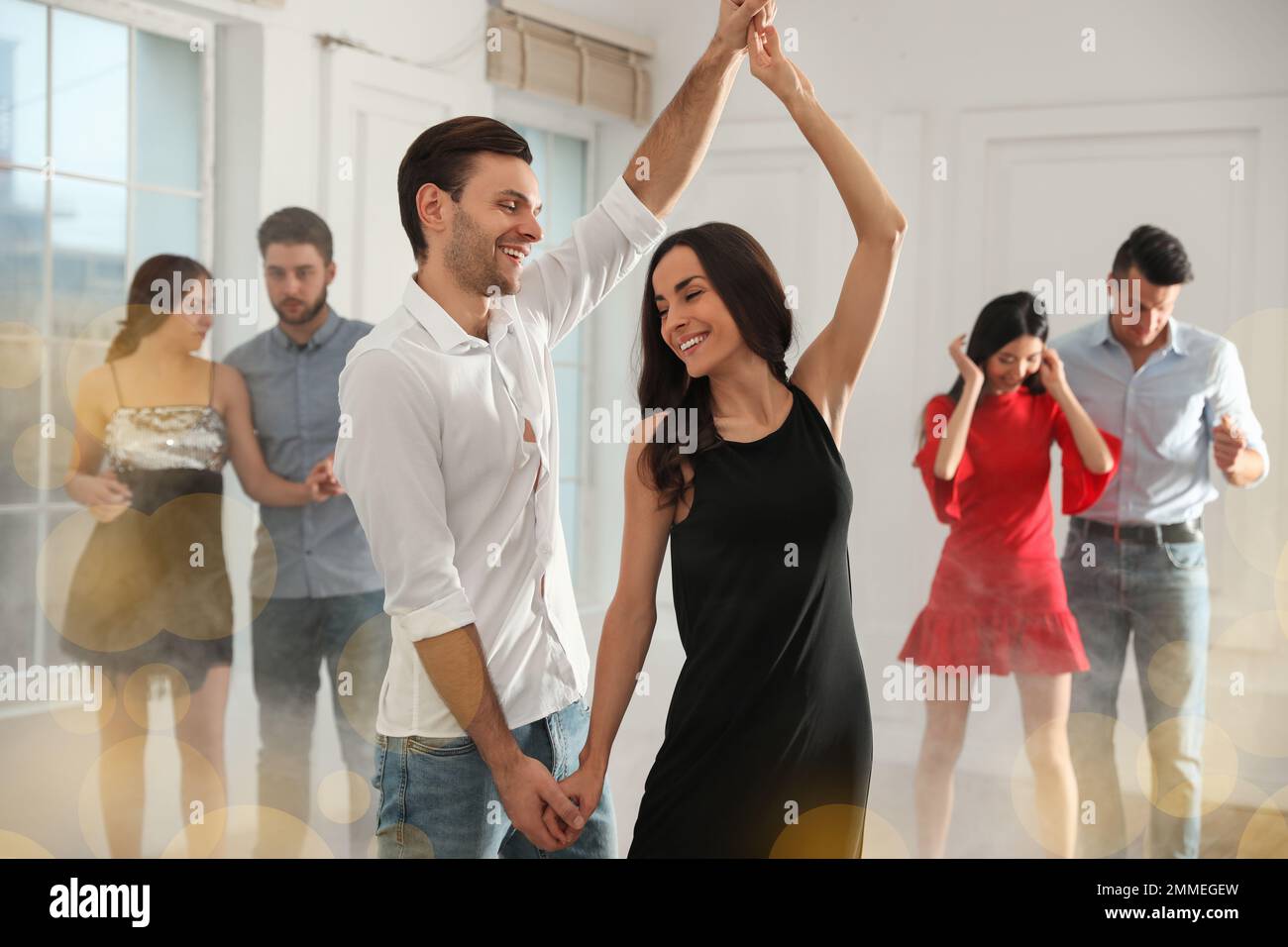 Lovely young couple dancing together at party Stock Photo - Alamy