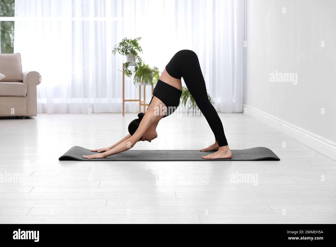 Professional young acrobat practicing yoga at home Stock Photo - Alamy