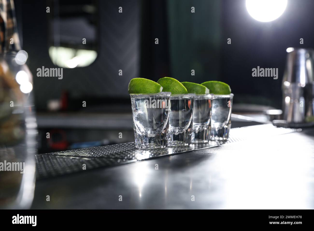 Mexican Tequila shots with lime slices on bar counter Stock Photo - Alamy