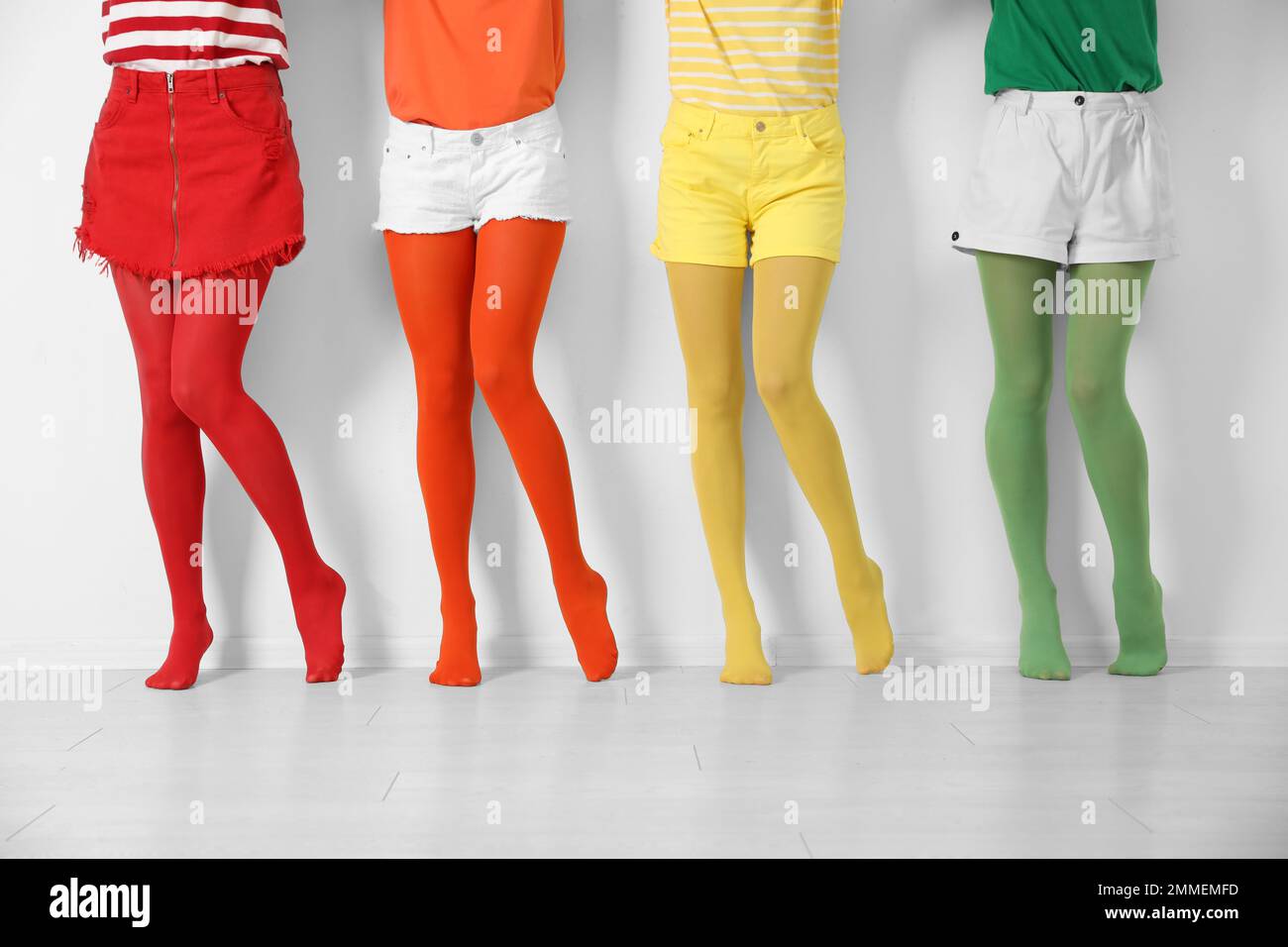 Women wearing bright tights near white wall, closeup Stock Photo - Alamy