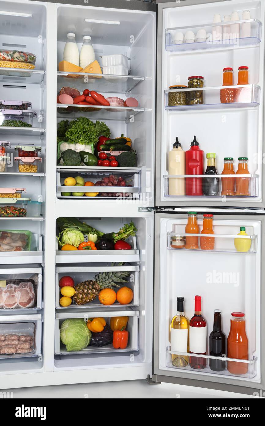 Open refrigerator full of different fresh products Stock Photo - Alamy