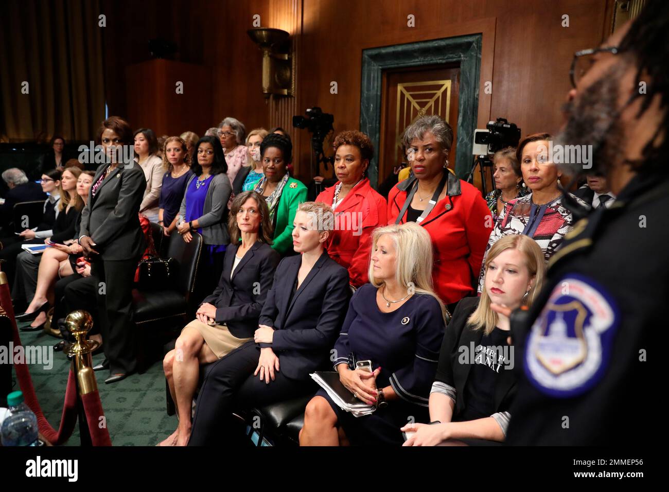 Female members of Congress stand in the Senate Judiciary Committee ...