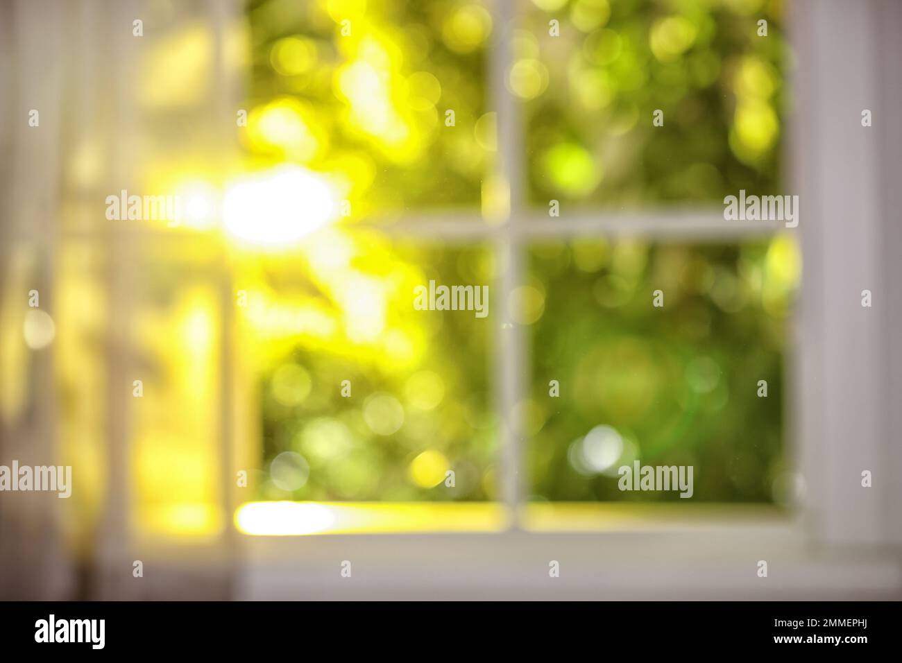 Blurred view through window on garden in morning Stock Photo - Alamy