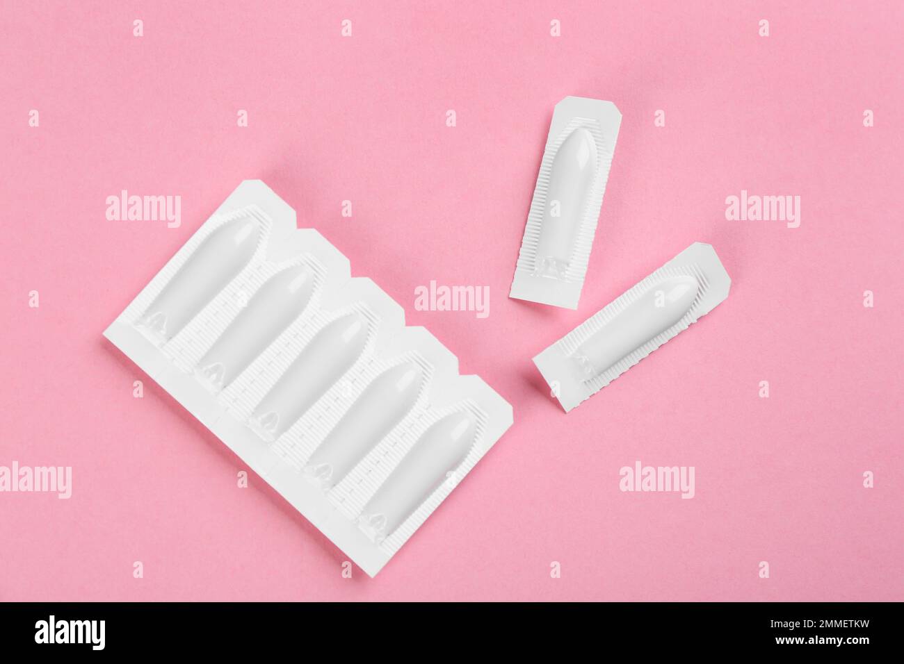 Suppositories on pink background, flat lay. Hemorrhoid treatment Stock ...