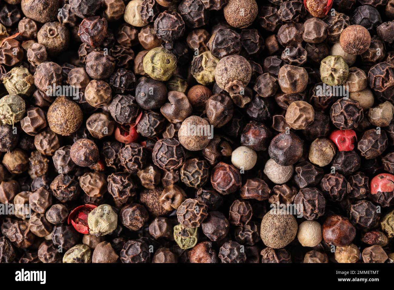 Pepper grains mix as background, top view Stock Photo - Alamy