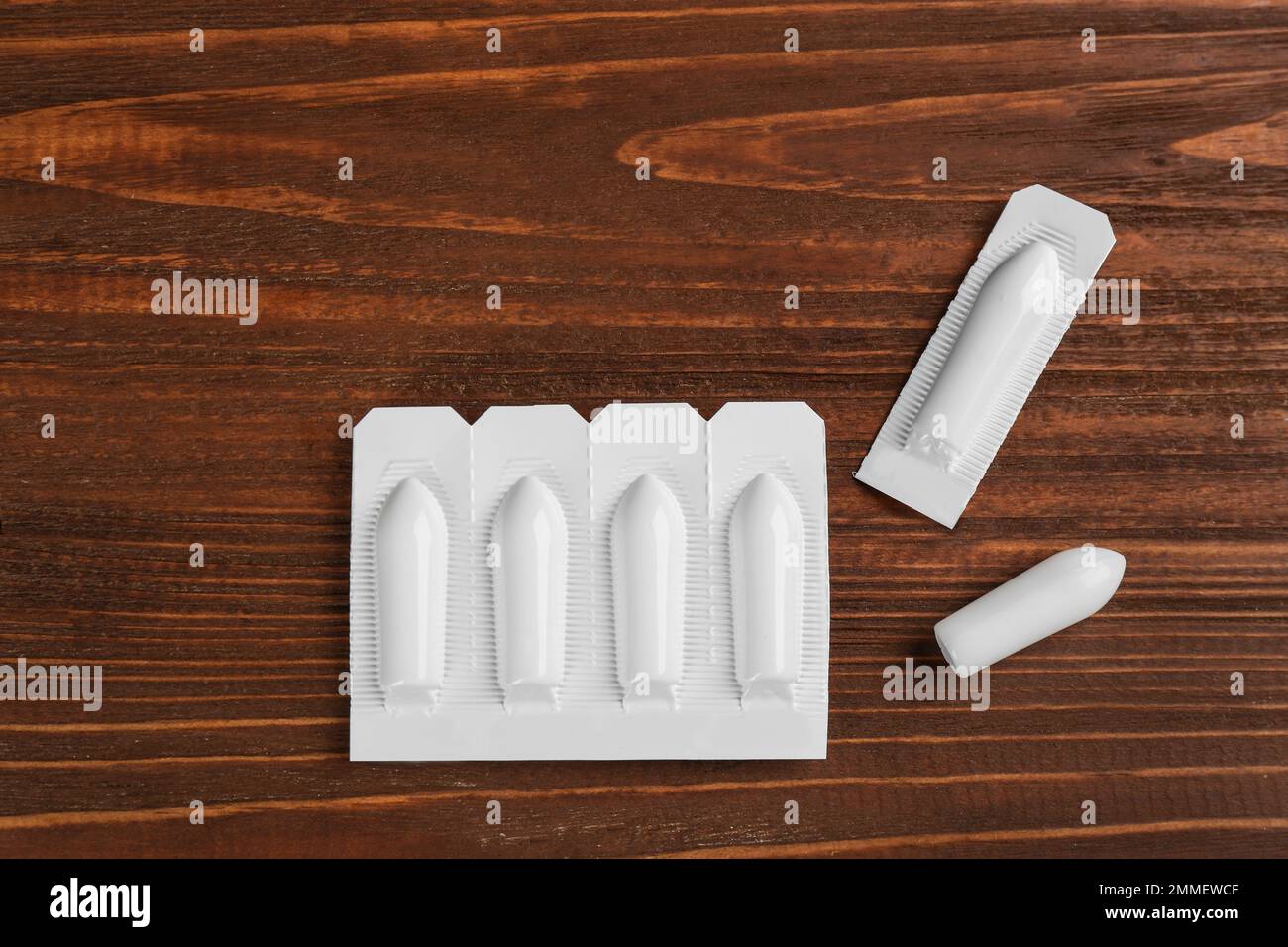 Suppositories on wooden background, flat lay. Hemorrhoid treatment ...