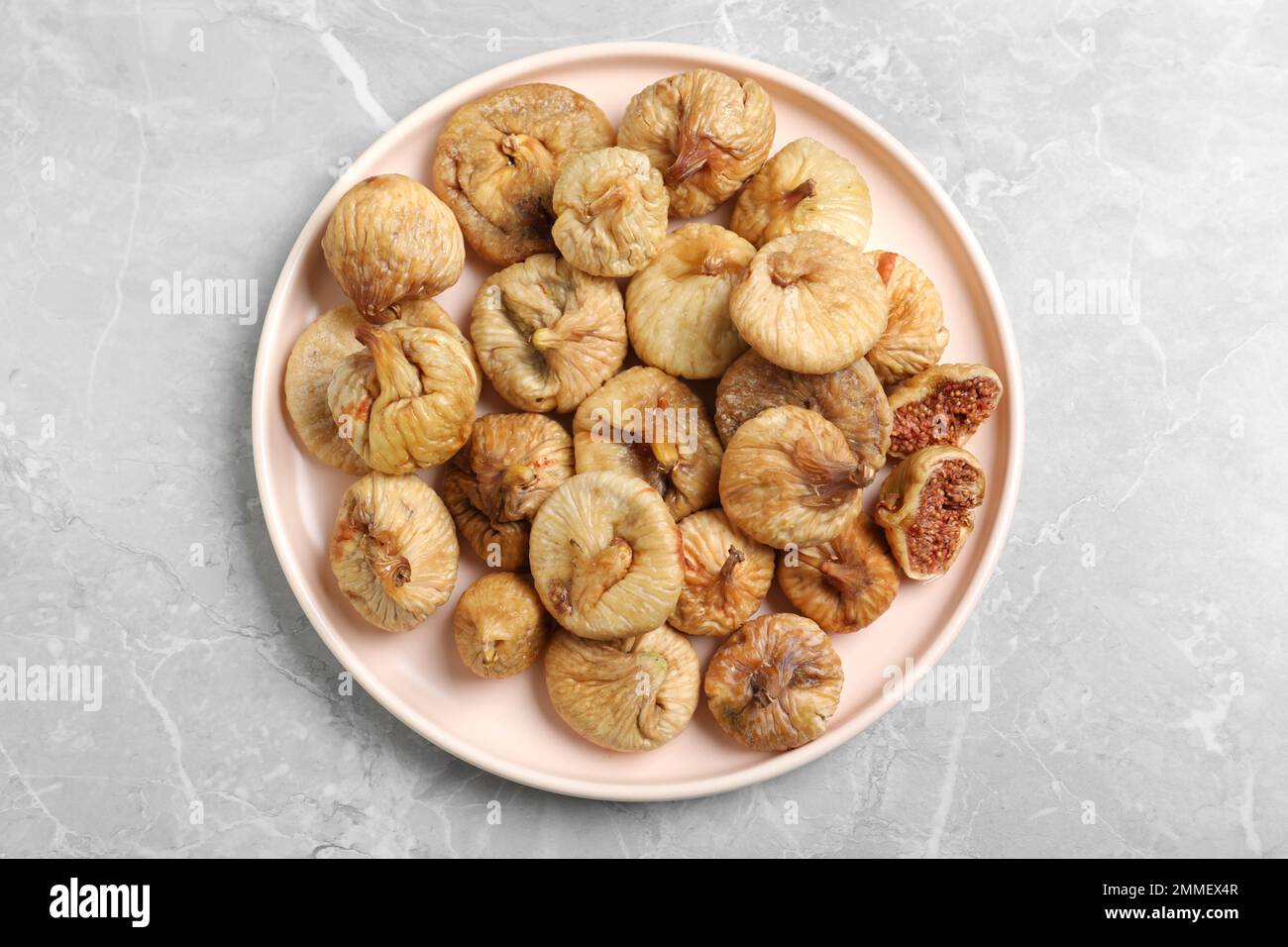Tasty dried figs on light grey marble table, top view Stock Photo - Alamy