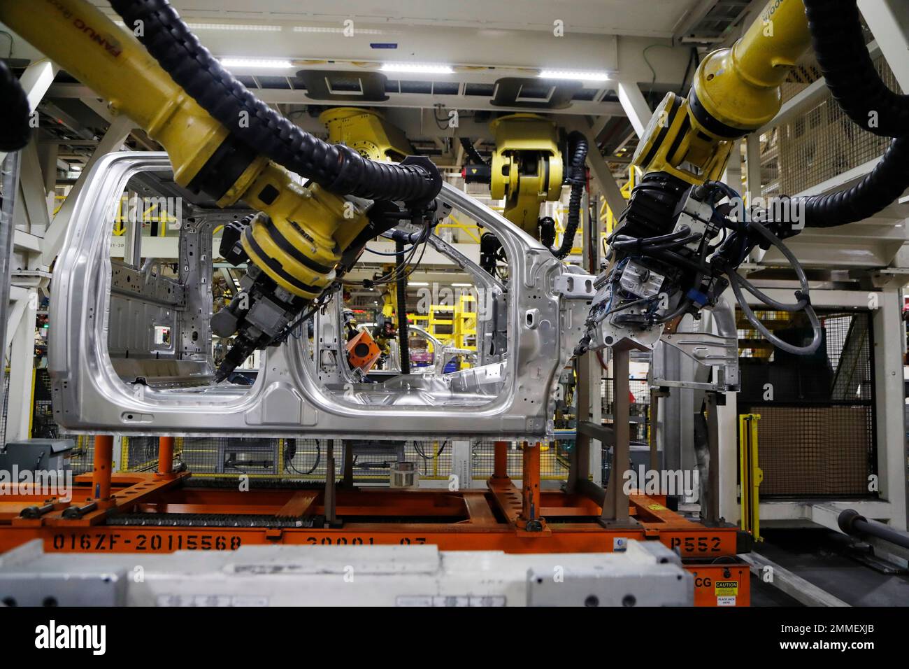 Robots weld the cab of a 2018 Ford F-150 truck on the assembly line at ...
