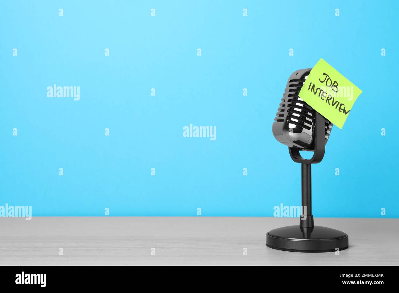 Retro microphone and reminder note with words JOB INTERVIEW on wooden ...