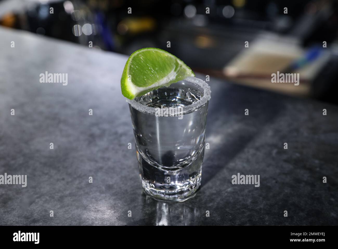 Mexican Tequila shot with lime slice on bar counter Stock Photo - Alamy