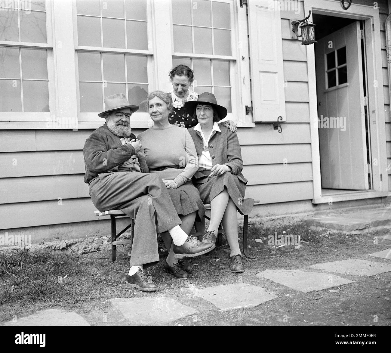 Sculptor, Jo Davidson, left, sits on a bench at his Bucks County studio ...