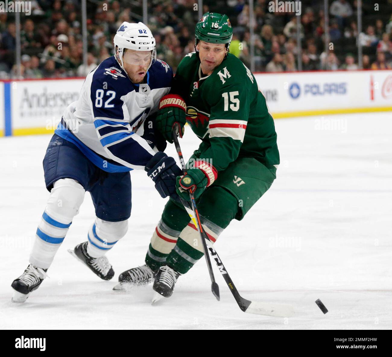 Minnesota Wild center Matt Hendricks (15) takes the puck from Winnipeg ...