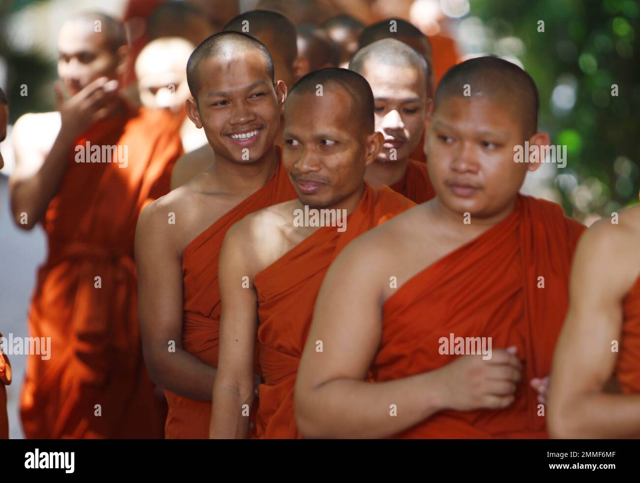 Buddhist monks enter a temple for lunch during a charity event ...