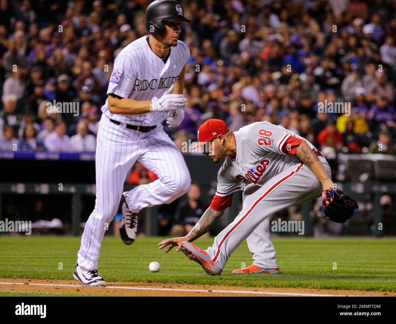 Philadelphia Phillies starting pitcher Vince Velasquez (28) scoops up a ...