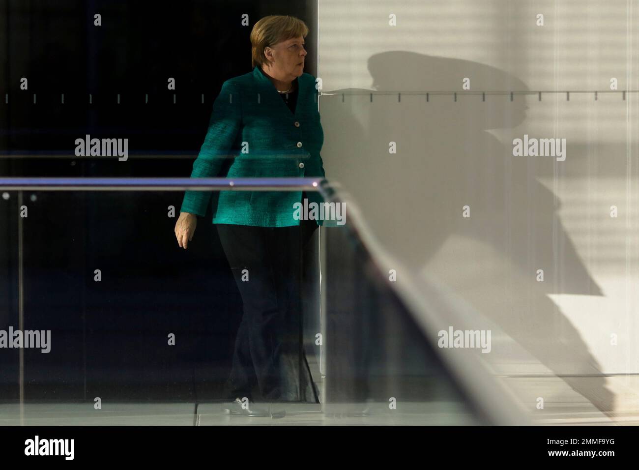 German Chancellor Angela Merkel walks through a corridor of the ...