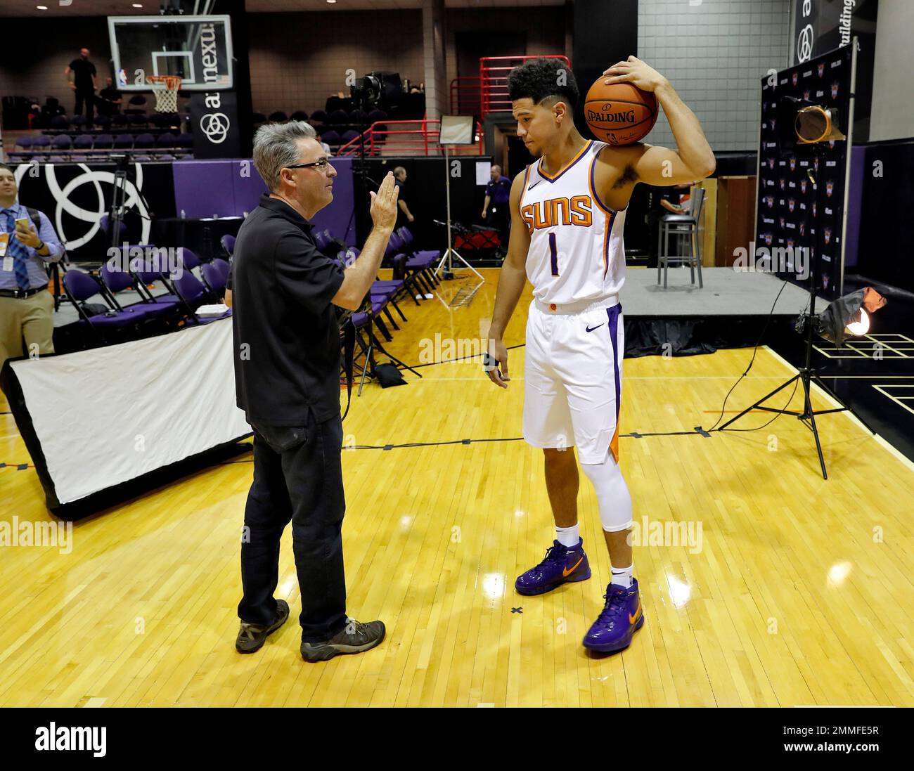Photographer Rob Schumacher poses Phoenix Suns' Devin Booker during ...
