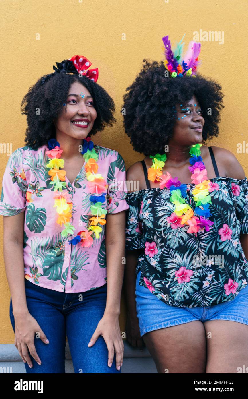 Two Afro Friends celebrating street carnival Stock Photo - Alamy