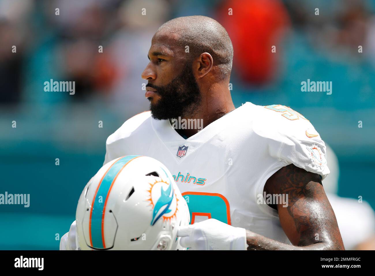 Miami Dolphins defensive end Andre Branch puts on his helmet during ...