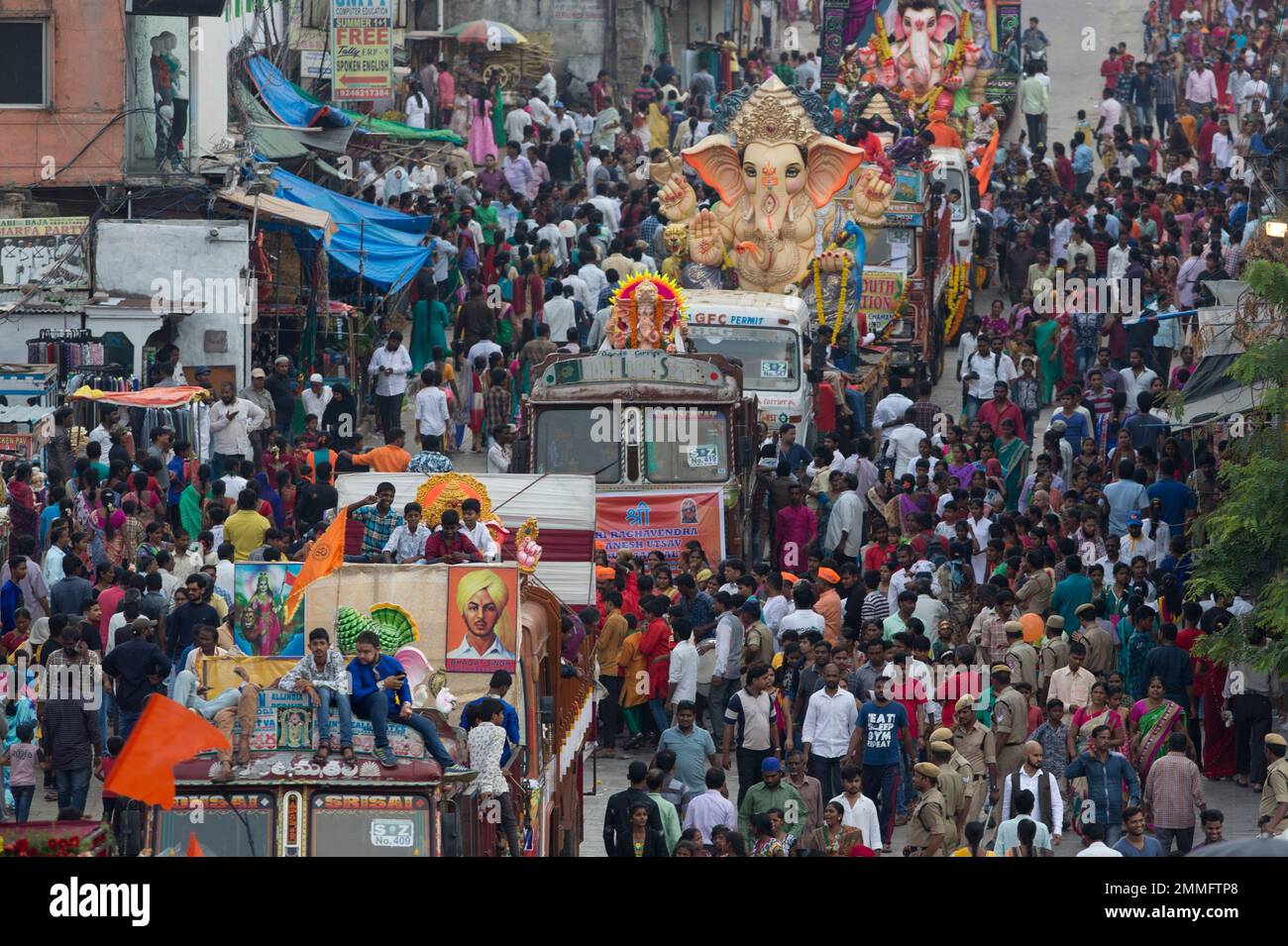 Idols of elephant-headed Hindu god Ganesha are taken in a procession ...